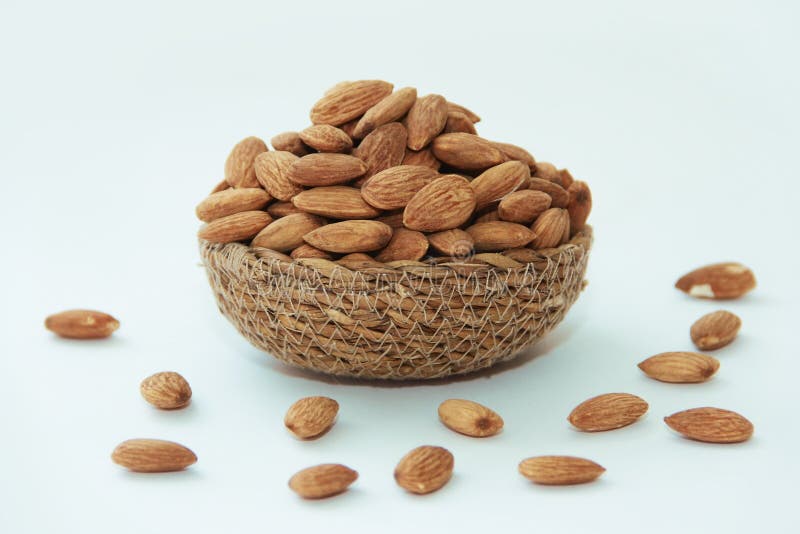 Small Brown Grains of Natural Almonds in a Decorative Plate on a Blue ...