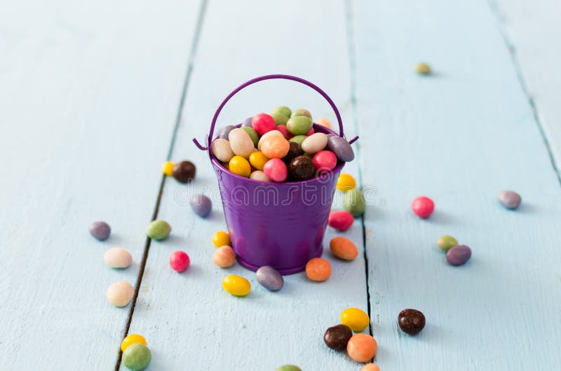 Small Bucket with Multi-colored Candies on a Wooden Table Stock Photo ...