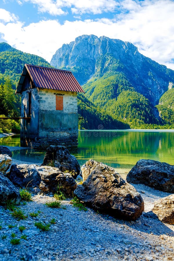 Small Building at a Beautiful Lake Surrounded by Stunning Mountain ...