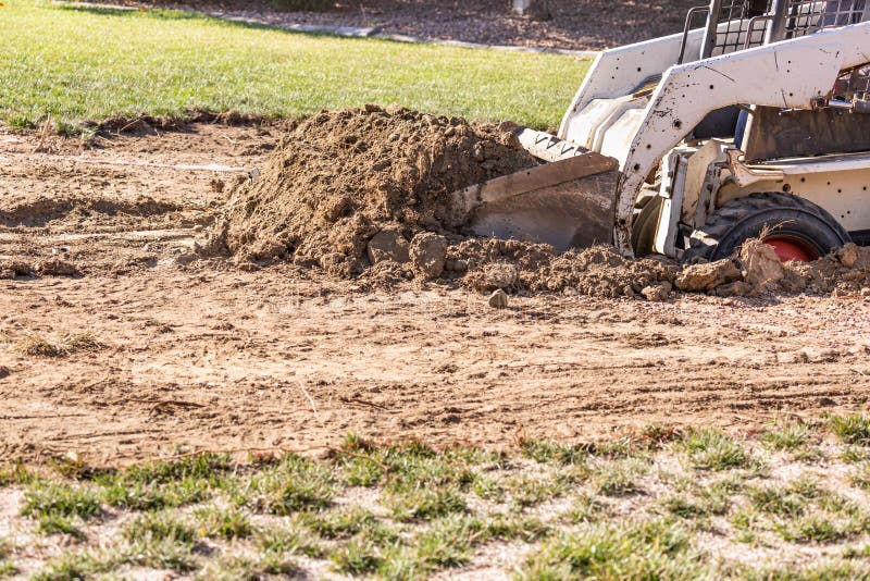 Small Bulldozer Digging in Yard for Pool Installation Stock Photo ...