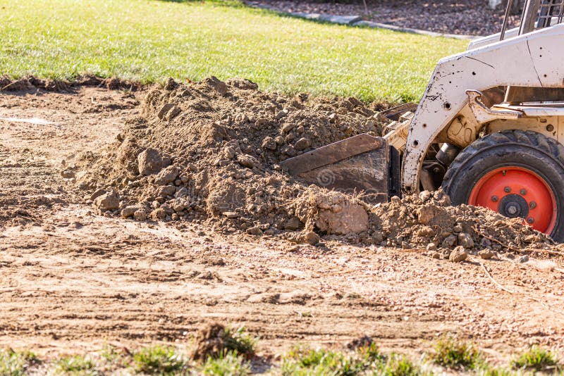 Small Bulldozer Digging in Yard for Pool Installation Stock Photo ...
