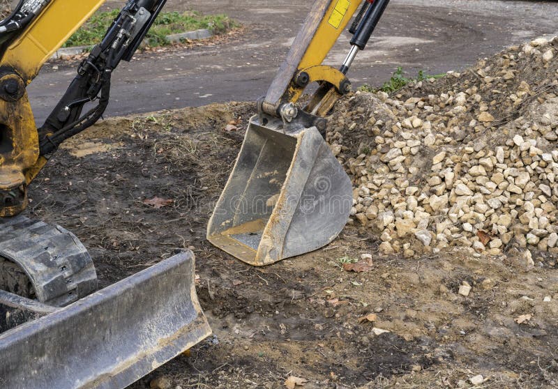 Small Bulldozer at Work. Orange Excavator on the Road Stock Image ...