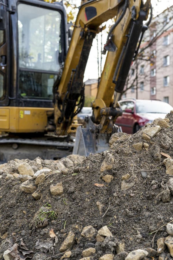 Small Bulldozer at Work. Orange Excavator on the Road Stock Image ...