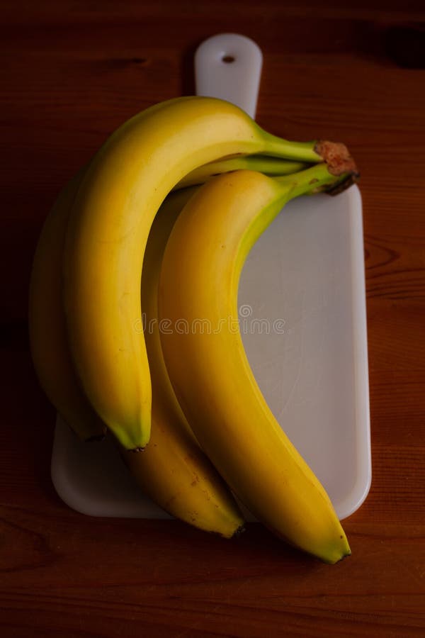 A Small Bunch of Yellow Bananas Stock Photo - Image of small, board ...