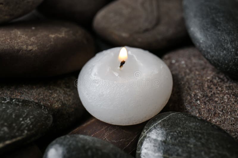 Small Burning Candle on Beautiful Spa Stones Stock Image - Image of ...