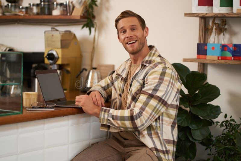 Small Business Concept. Handsome Businessman, Cafe Owner, Sitting Near ... Small Business Concept. Handsome Businessman, Cafe Owner, Sitting Near ...