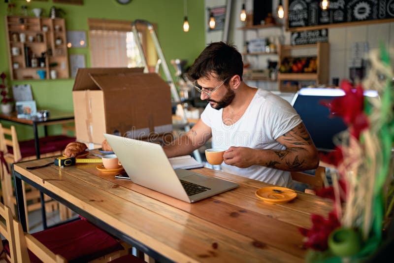 Business Owner in Coffee Shop Working on Laptop Stock Image - Image of ...