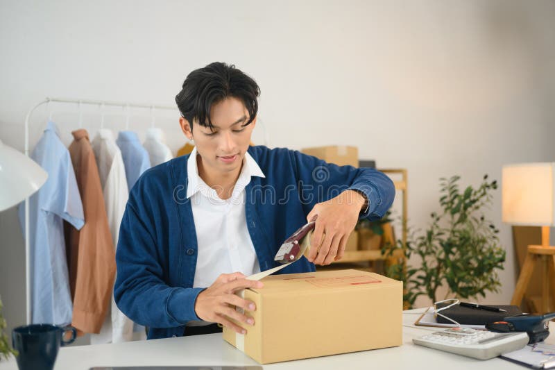 Small Business Owner Packing an Order in a Home Office Stock Image ...
