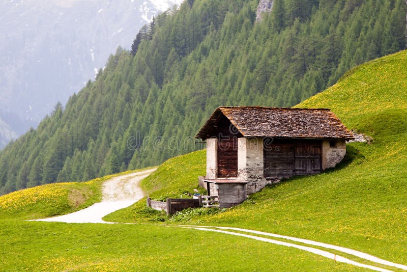 Small Cabin on a Rural Green Field in the Alps Stock Photo - Image of ...