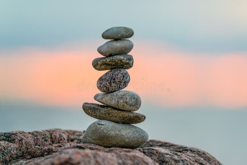 A Small Cairn Placed on a Rock at Sunset Stock Photo - Image of ...
