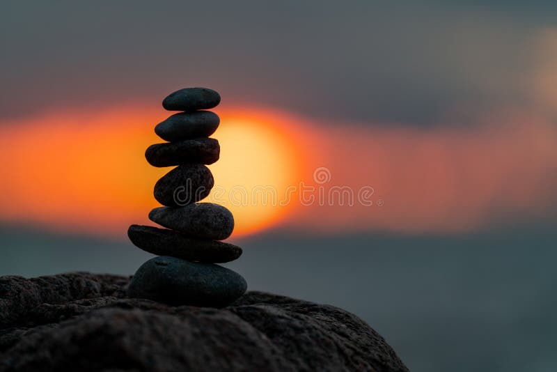A Small Cairn Placed on a Rock at Sunset Stock Photo - Image of ocean ...