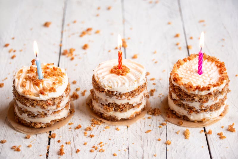 Small Cakes with Candles on White Background Stock Photo - Image of ...