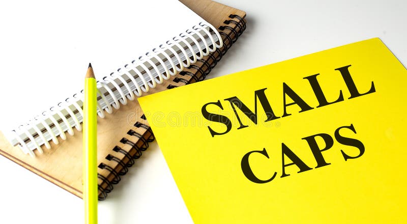 Small Caps Concept with Yellow Document, Pencil, and Spiral Notebooks ...