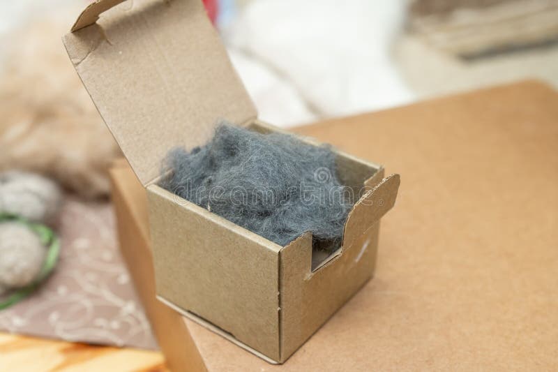 Small Cardboard Box with Fluffy Grey Material on a Table Stock Photo ...