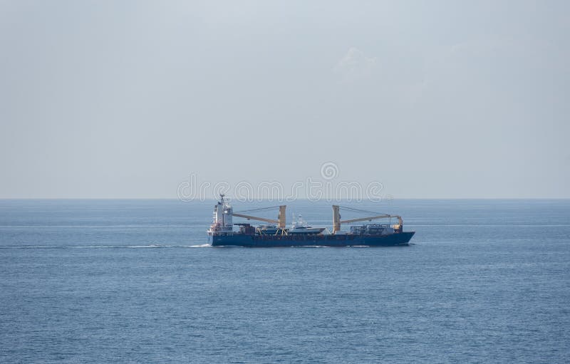 Small Cargo Ship Sailing through the Calm Sea. Stock Photo - Image of ...