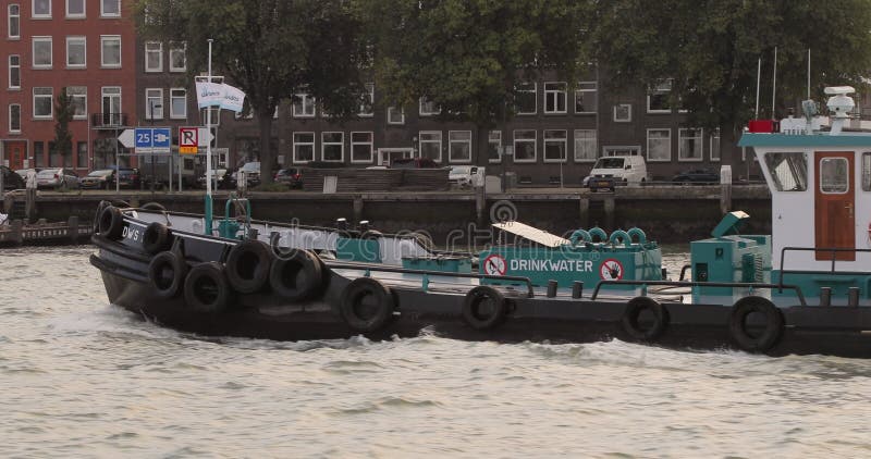 Small Cargo Ship Sailing through Rotterdam with Drinking Water ...