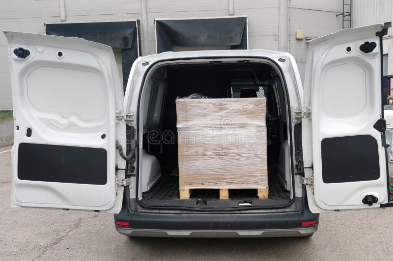 A Small Cargo Van with Cargo on a Pallet in the Car Stock Photo - Image ...