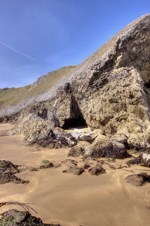 A small cave on a beach stock image. Image of beach, golden - 26761001