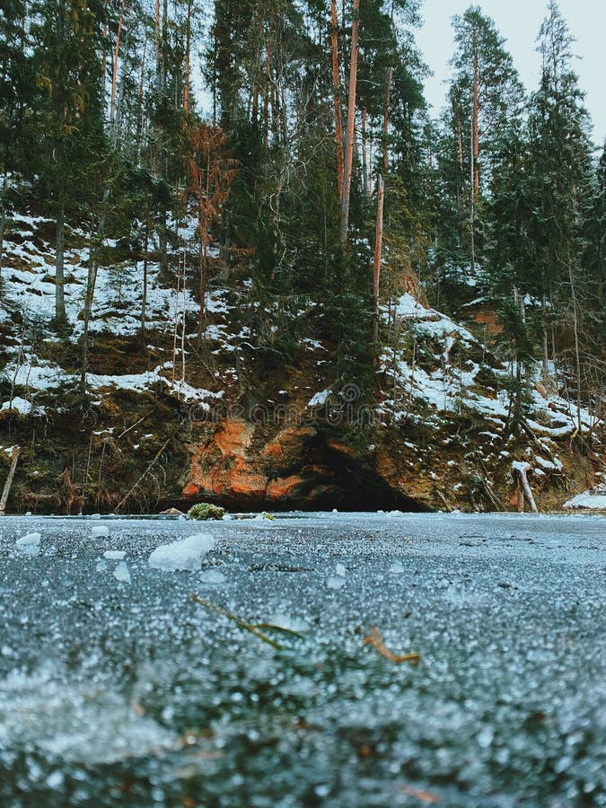 Small Cave in a Forest Partially Covered with Snow Stock Photo - Image ...