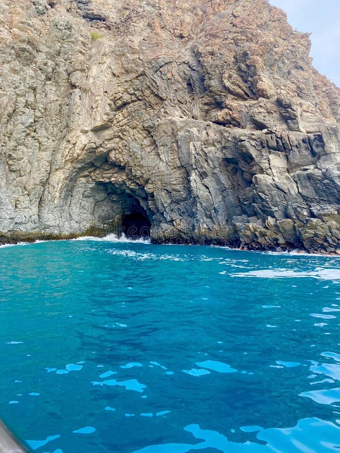 A Small Cave in a Stone Cliff Stock Photo - Image of shore, clear ...