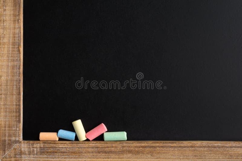 Small Chalk Pieces in Different Colors on a Blackboard Stock Photo ...