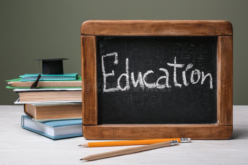 Small Chalkboard with Word EDUCATION and Stack of Books with Stationery ...