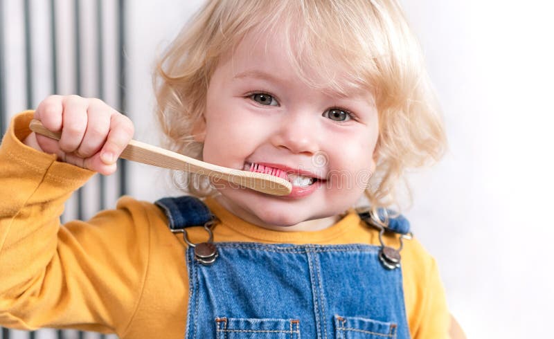 A Small Child Brushes His Teeth with an Eco-friendly Brush Stock Photo ...