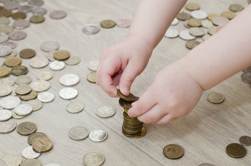 Child Builds a Tower of Coins Stock Photo - Image of investment, finger ...