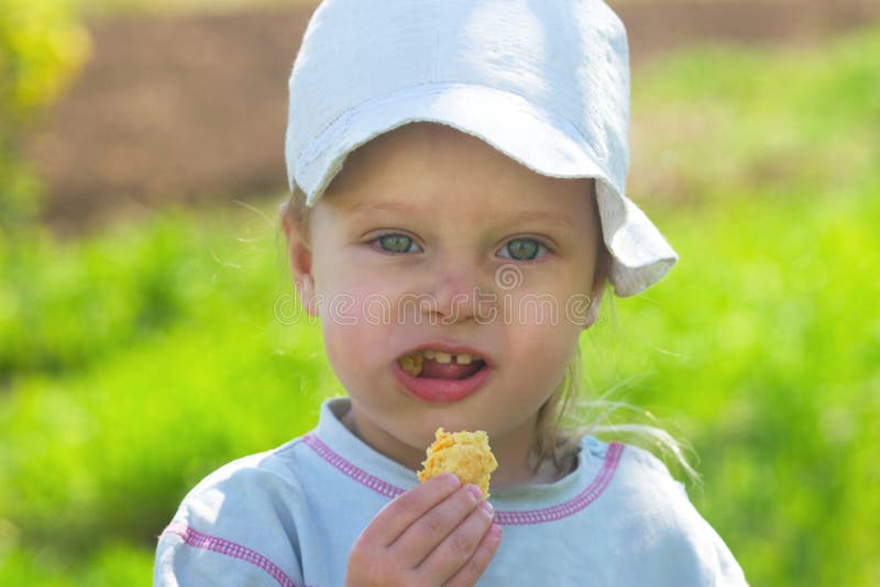 Small Child in a Cap Eating Cookies Stock Photo - Image of mouth ...