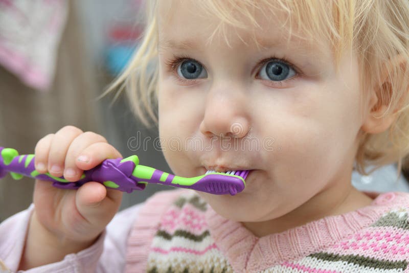 A Small Child Cleans Children`s Teeth with a Toothbrush Stock Photo ...