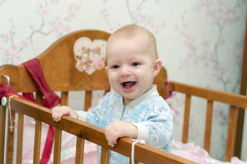 A small child is in a cot stock image. Image of crib - 186989033