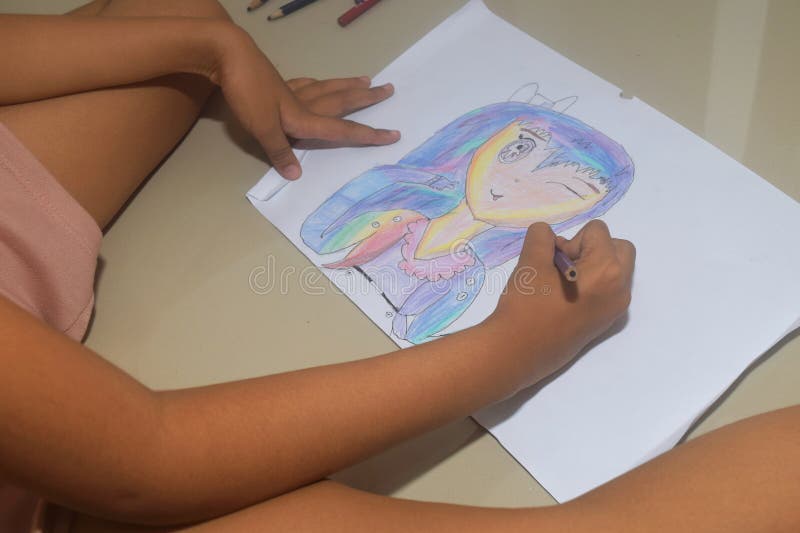 A Small Child is Drawing and Coloring an Work Made on Paper Stock ...