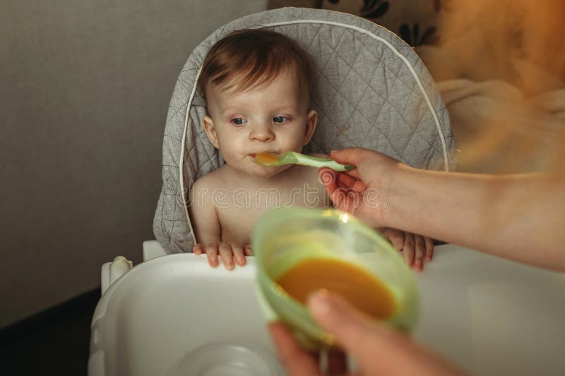 A Small Child Eats Vegetable Puree. Mom Feeds the Baby Stock Image ...