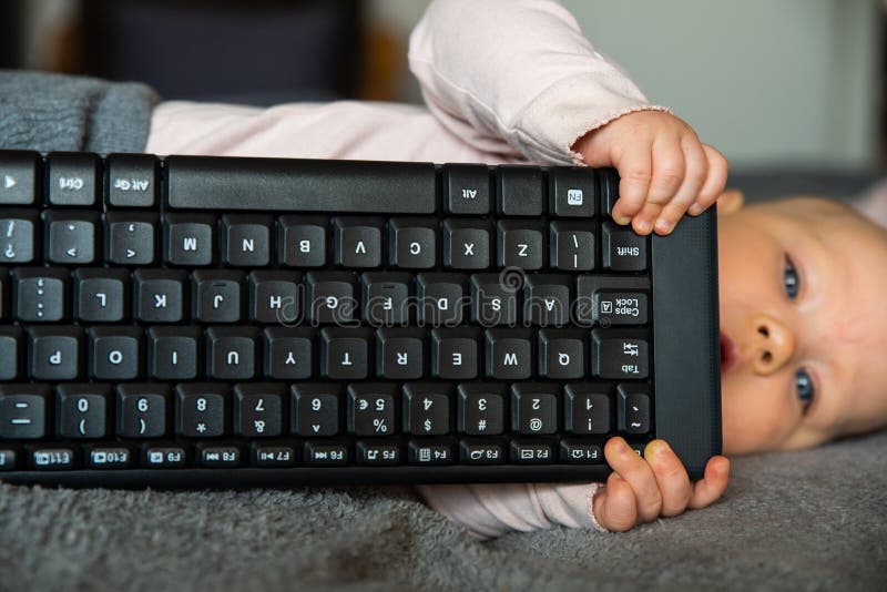 Small Child, First Steps on the Internet, a Newborn Baby is Holding a ...