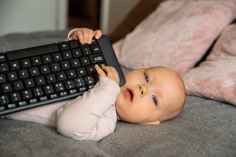 Small Child, First Steps on the Internet, a Newborn Baby is Holding a ...