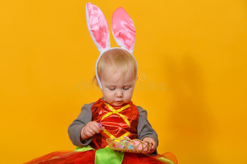 A Small Child, a Girl Clown with Rabbit Ears Holds Easter Eggs in Her ...
