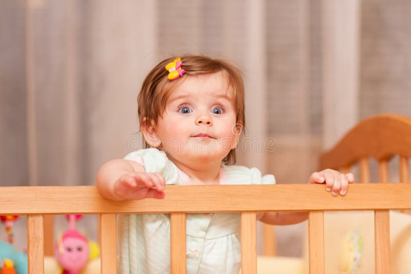 Small Child with a Hairpin Standing in Crib. Stock Image - Image of ...