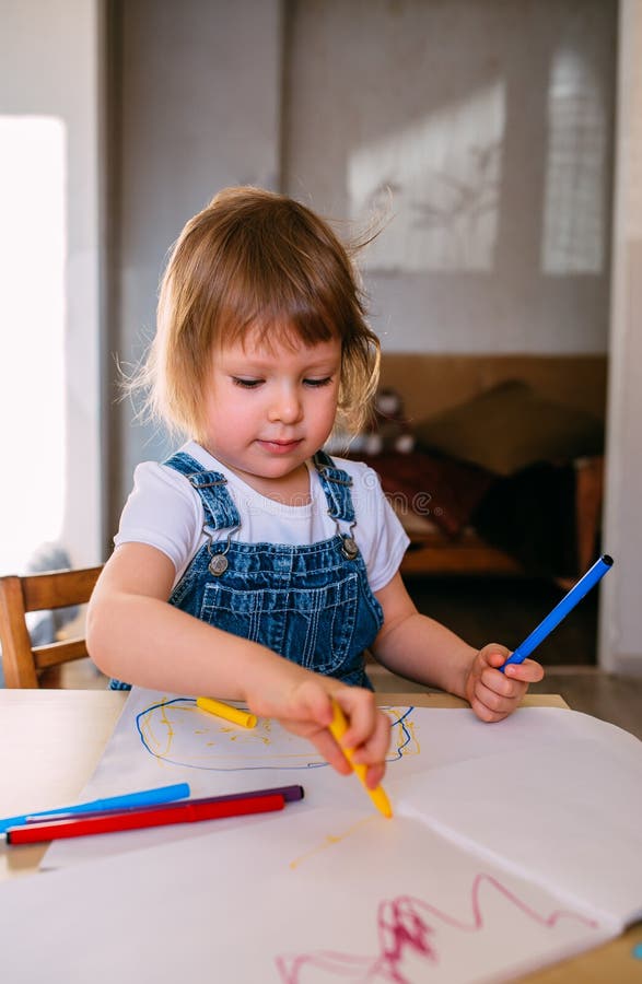 Small Child at Home at the Children S Table Draws with Felt-tip Pens ...