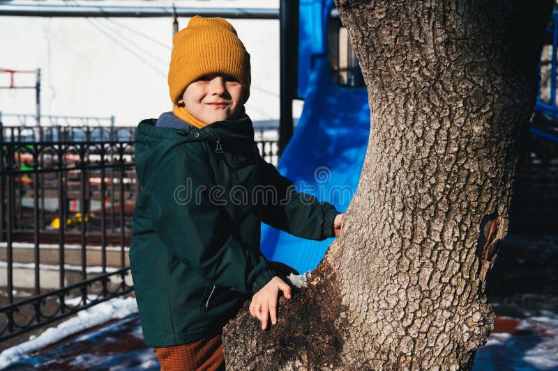 Small Child Kid Boy Plays and Climbs a Tree on Playground in Autumn ...