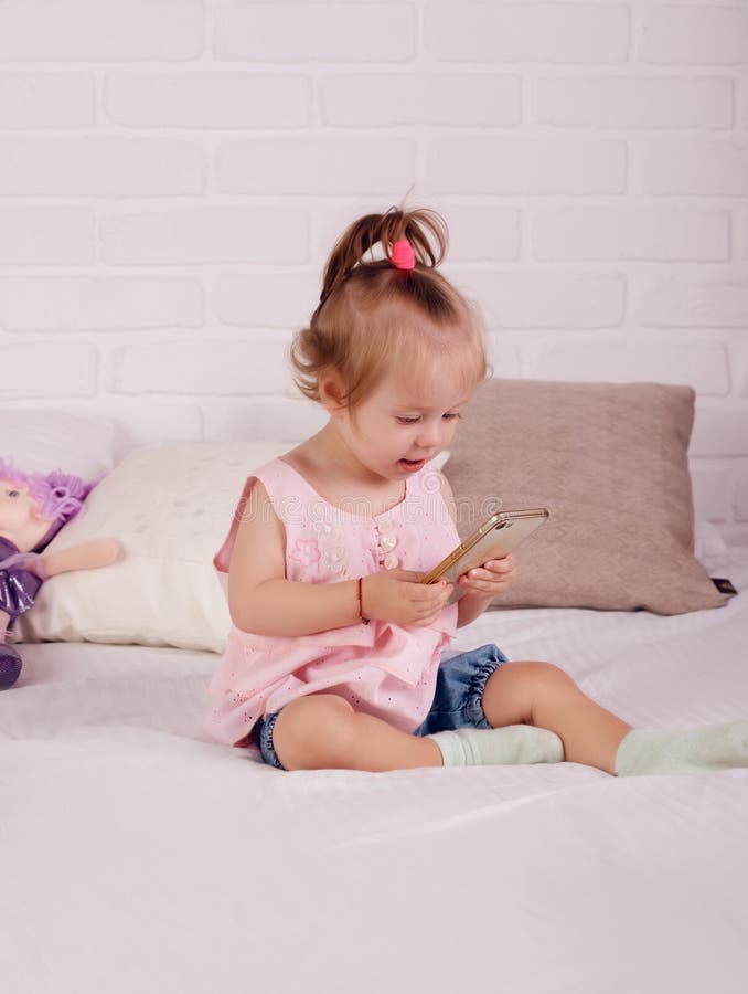 Small Child with a Phone. the Child is Using a Mobile Phone Stock Photo ...