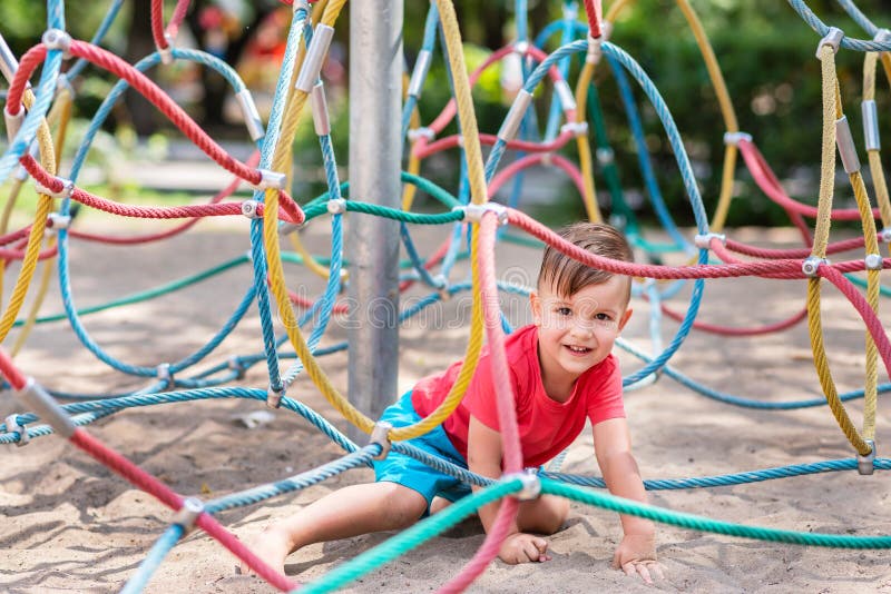 Little Boy Playing in the Rope Net on the Playground Stock Image ...