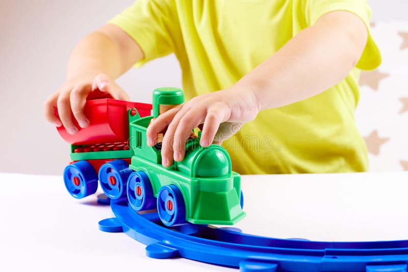A Small Child Plays with a Train and a Railroad. Games at Home or in ...