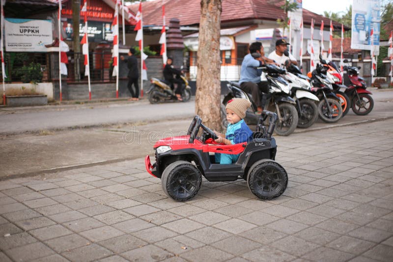 A Small Child is Riding in a Mini Car Which is Controlled by Using a ...
