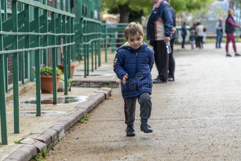 Small Child Running Towards the Camera Stock Photo - Image of coat ...