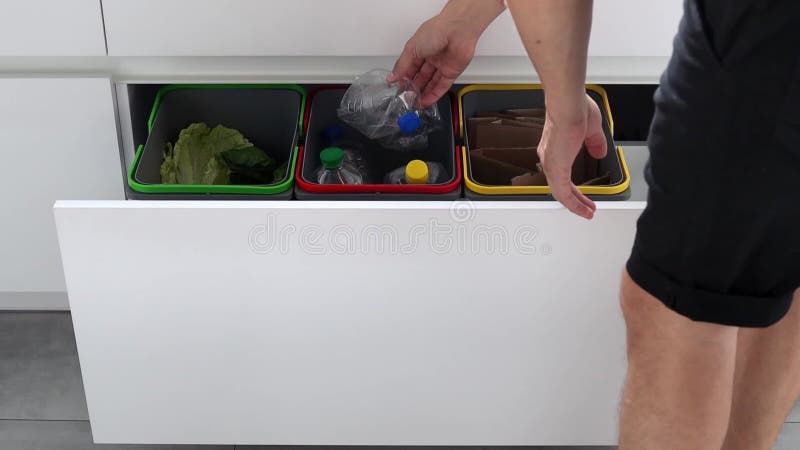 A Young Man Sorts Garbage in Containers in the Kitchen in Slow Motion ...