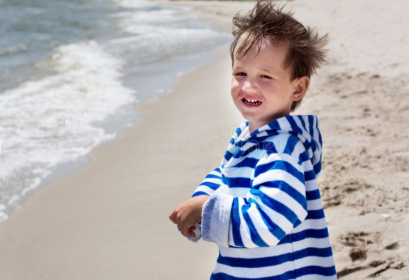 A Small Child is Standing on the Seashore Looking and Smiling, Stock ...