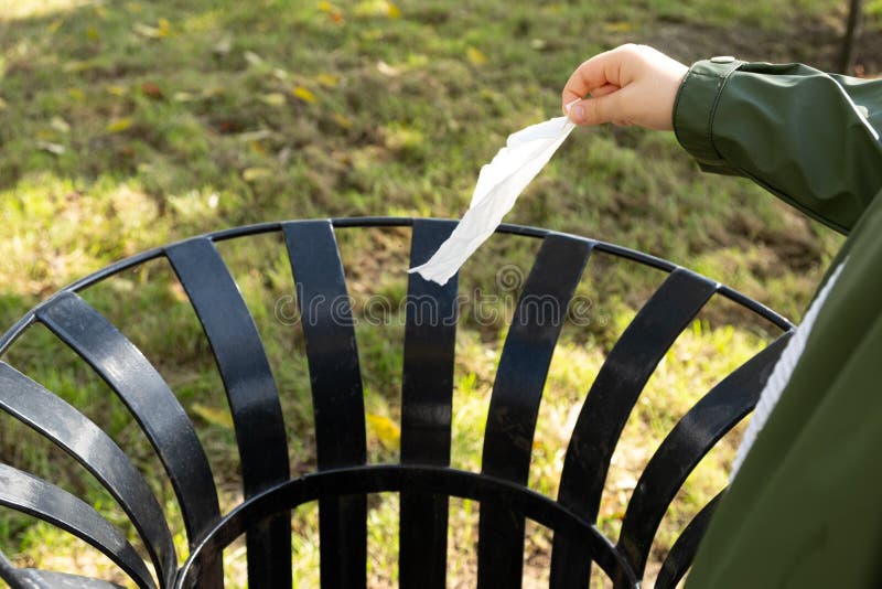 A Child Throws a Plastic Cup in the Trash. Garbage Recycling and ...