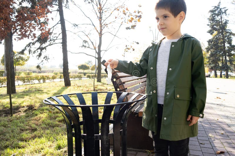 A Small Child Throws Wet Wipe Trash into the Trash Bin. Garbage Sorting ...