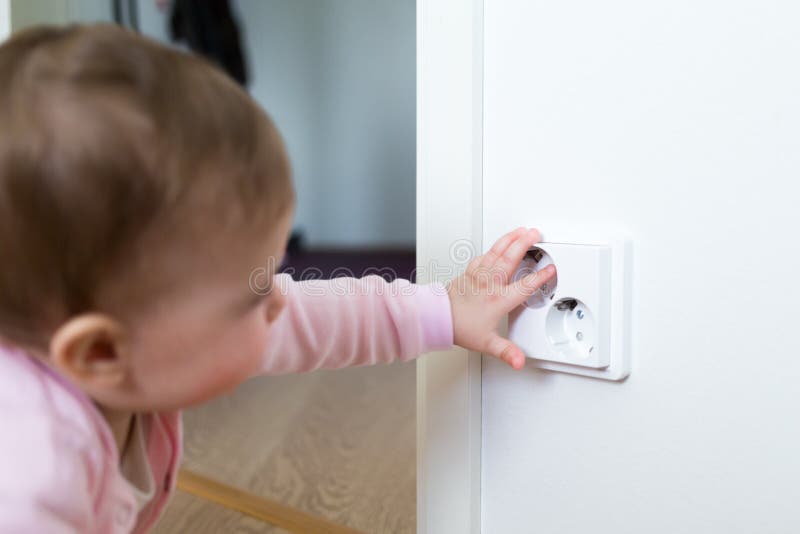 Small Child Touches an Electrical Outlet at Home. Safety of Children ...