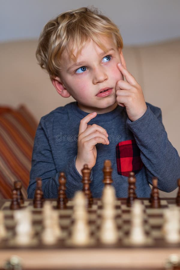 Small Child 5 Years Old Playing a Game of Chess on Large Chess Board ...